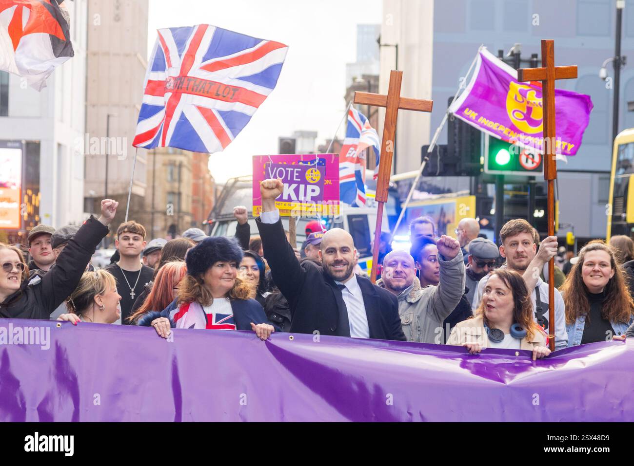 Manchester, UK. 22 FEB, 2025. Nick Tenconi, leader of Ukip, raises a ...