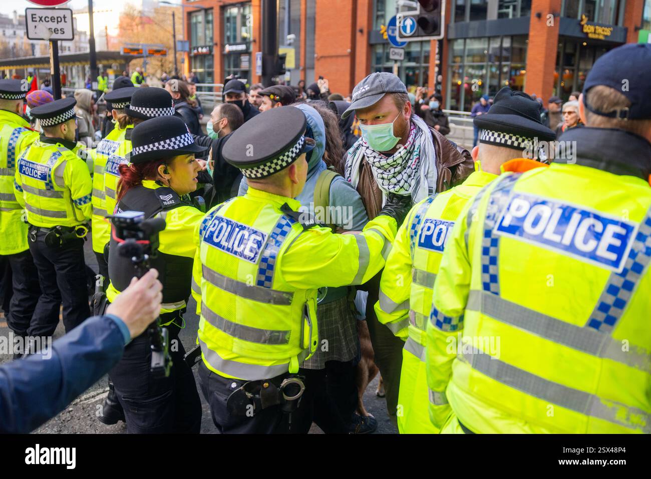 Manchester, UK. 22 FEB, 2025. Police kettle counter demonstrator as ...