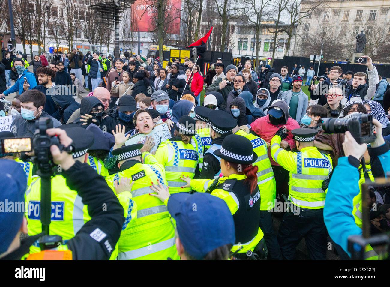 Manchester, UK. 22 FEB, 2025. Police kettle counter demonstrator as ...
