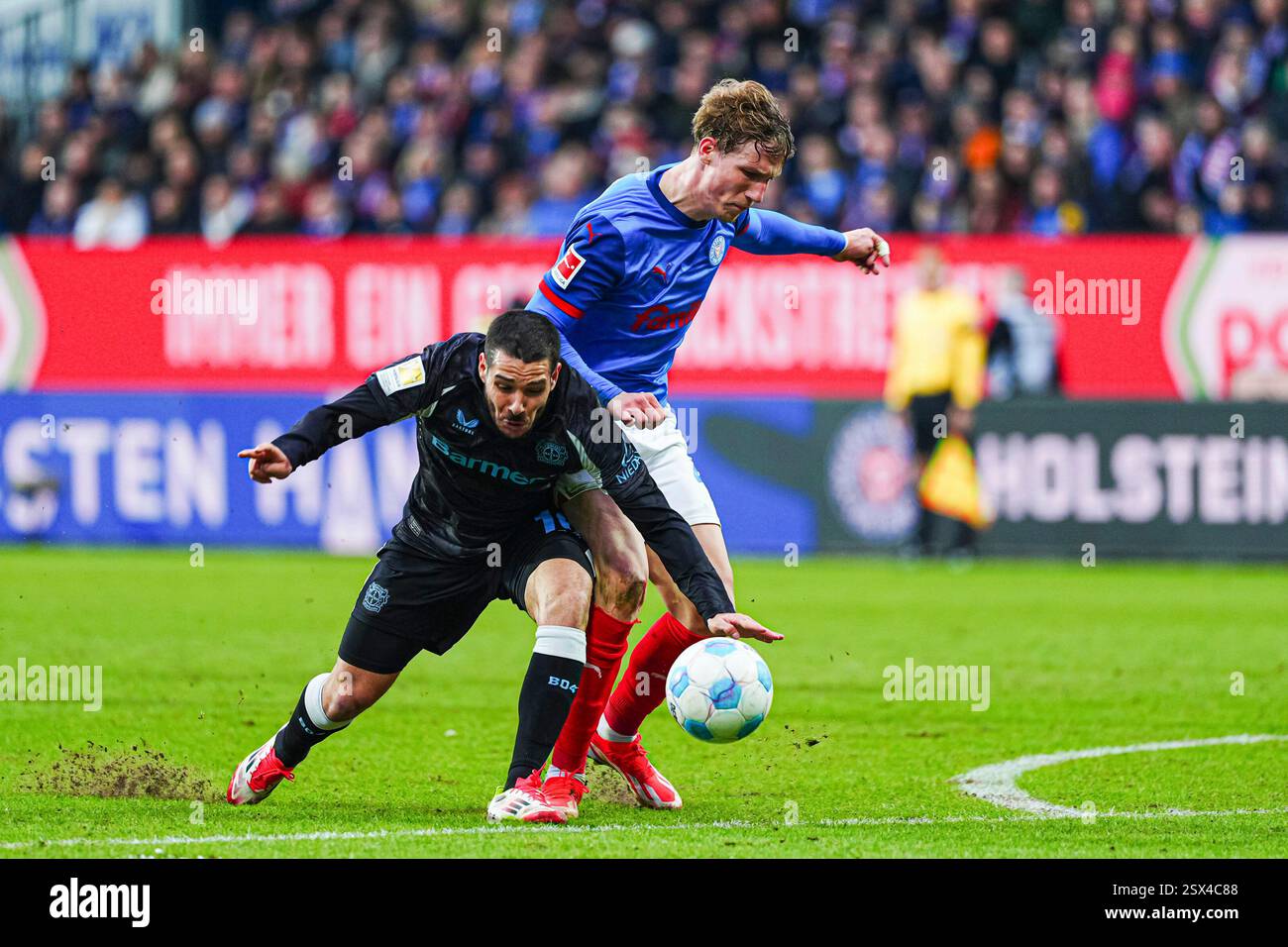 Kiel, Deutschland. 22nd Feb, 2025. Emiliano Buendia (Bayer 04 Leverkusen, #16), Lasse Rosenboom ...