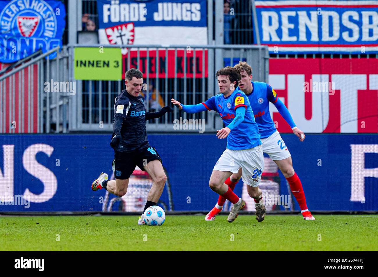 Kiel, Deutschland. 22nd Feb, 2025. Florian Wirtz (Bayer 04 Leverkusen, #10), Magnus Knudsen ...