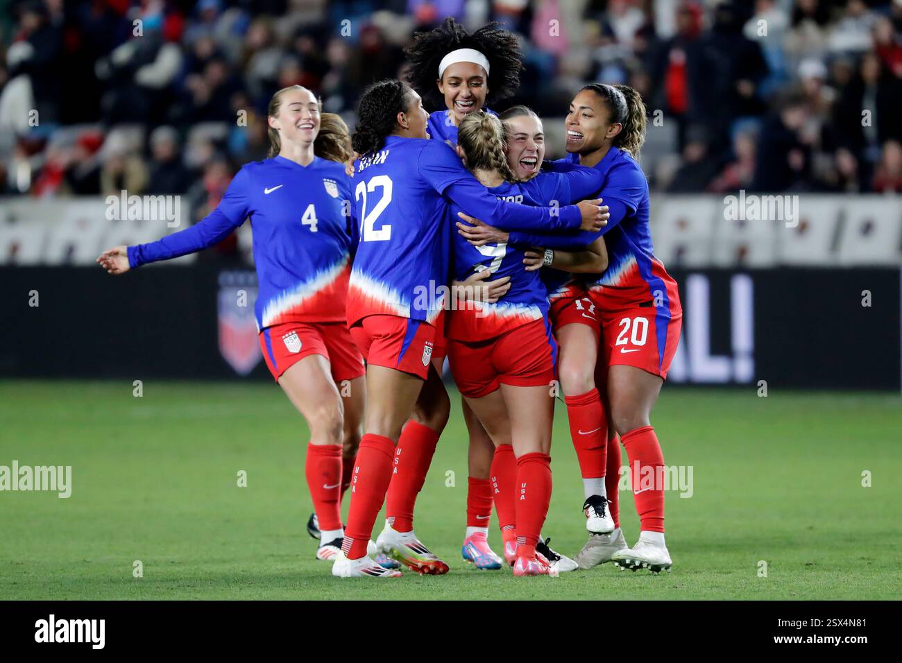 United States players swarm Ally Sentnor, center front, as they ...