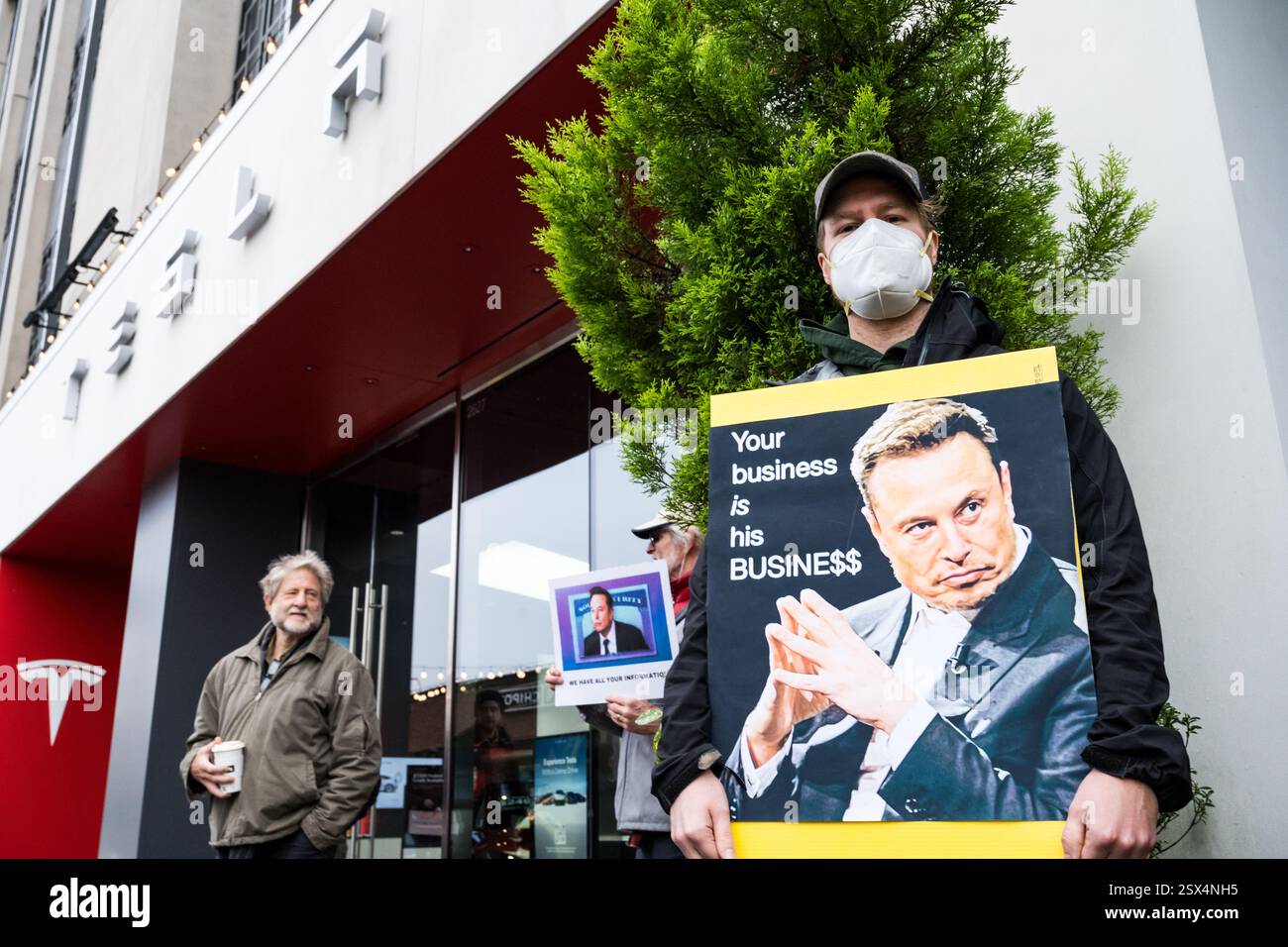 Seattle, USA. 22 Feb 2025. Activists at the Tesla dealership in the U ...