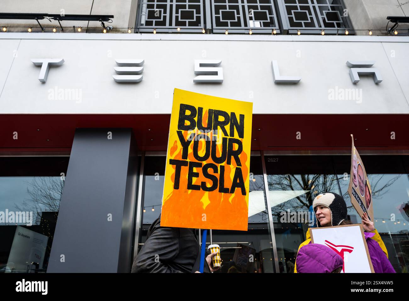 Seattle, USA. 22 Feb 2025. Activists at the Tesla dealership in the U ...