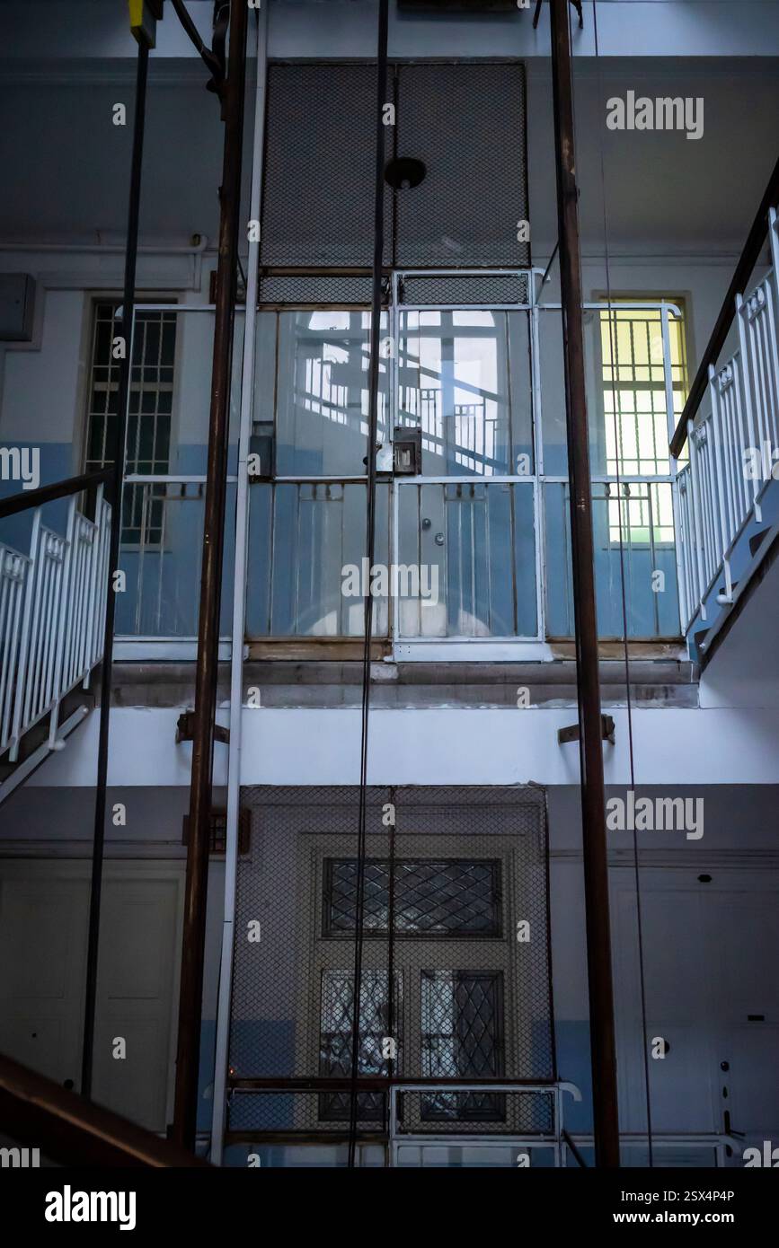 Interior staircase shaft and elevator cables in an old apartment ...