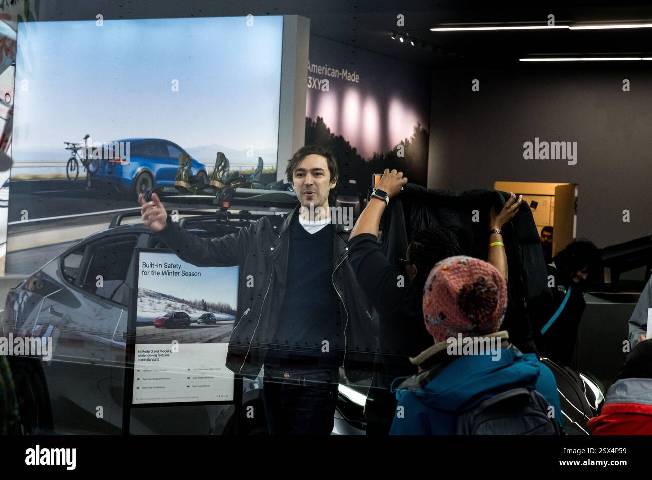 Seattle, USA. 22 Feb 2025. Activists fill the Tesla U Village ...