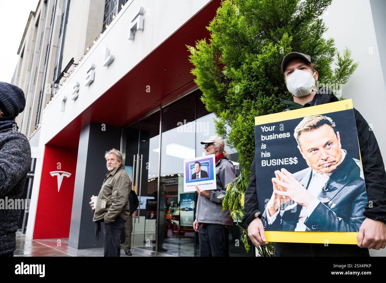 Seattle, USA. 22 Feb 2025. Activists at the Tesla dealership in the U ...