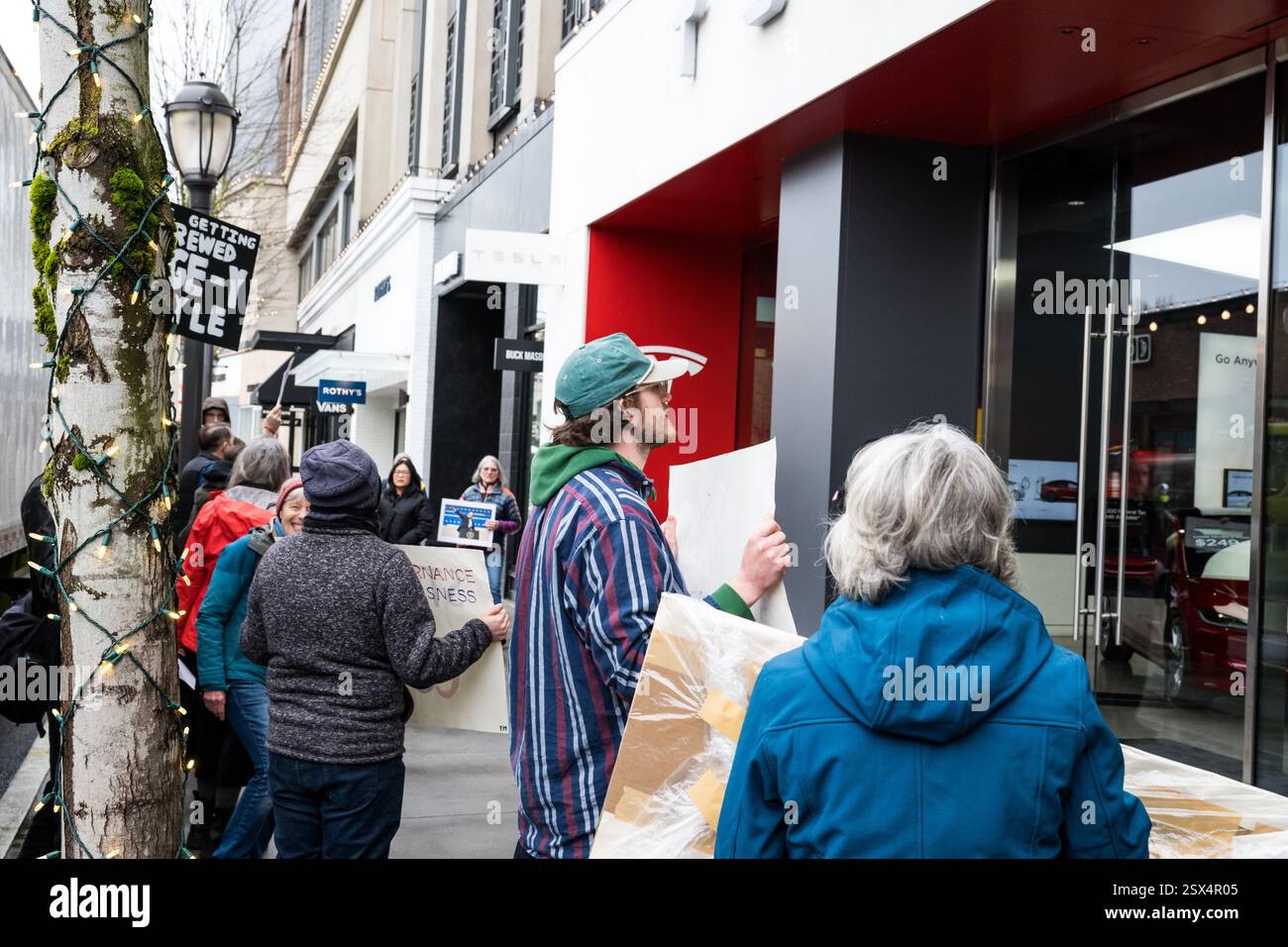 Seattle, USA. 22 Feb 2025. Activists at the Tesla dealership in the U ...