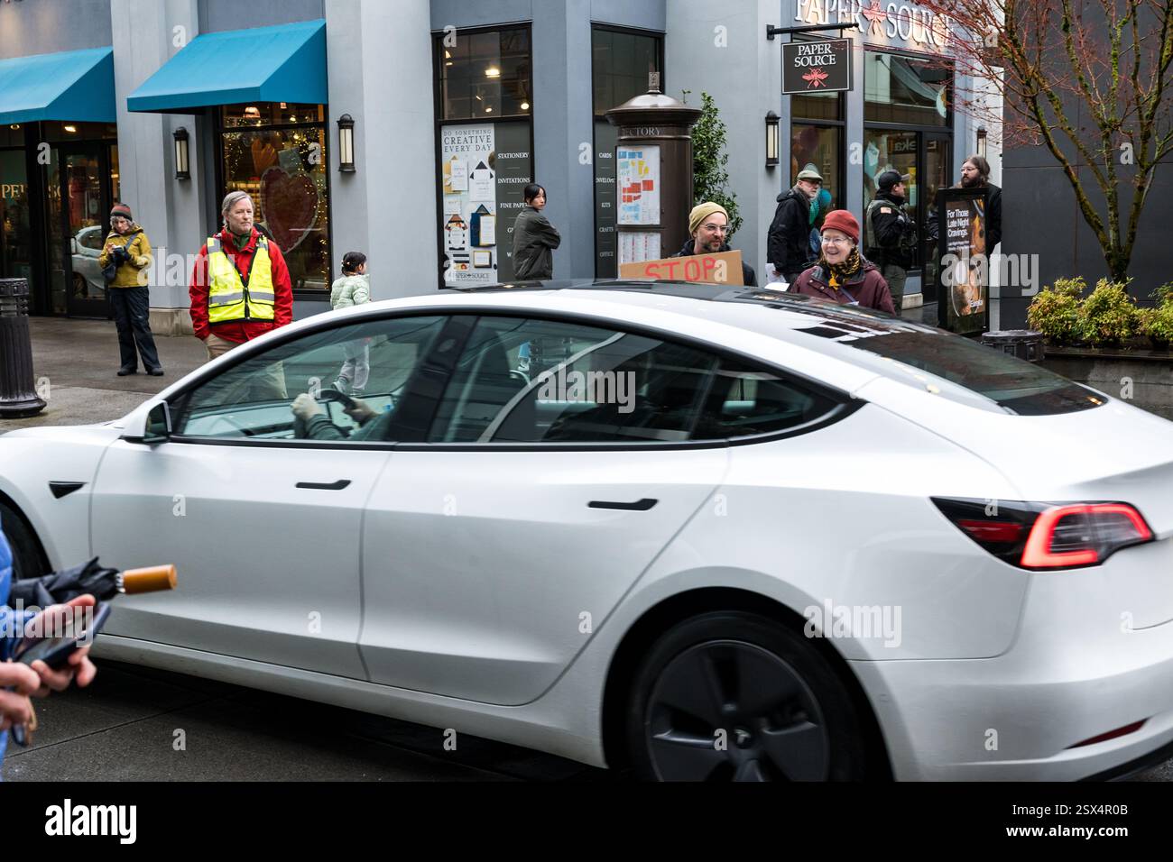 Seattle, USA. 22 Feb 2025. Activists at the Tesla dealership in the U ...