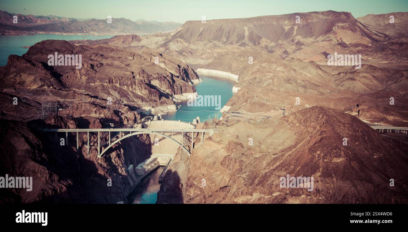 Bridge spans a river in the desert. The bridge is over a large body of ...
