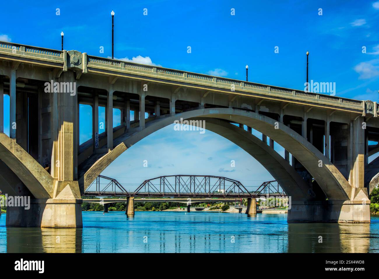 Bridge over a river with a train crossing underneath. The bridge is ...
