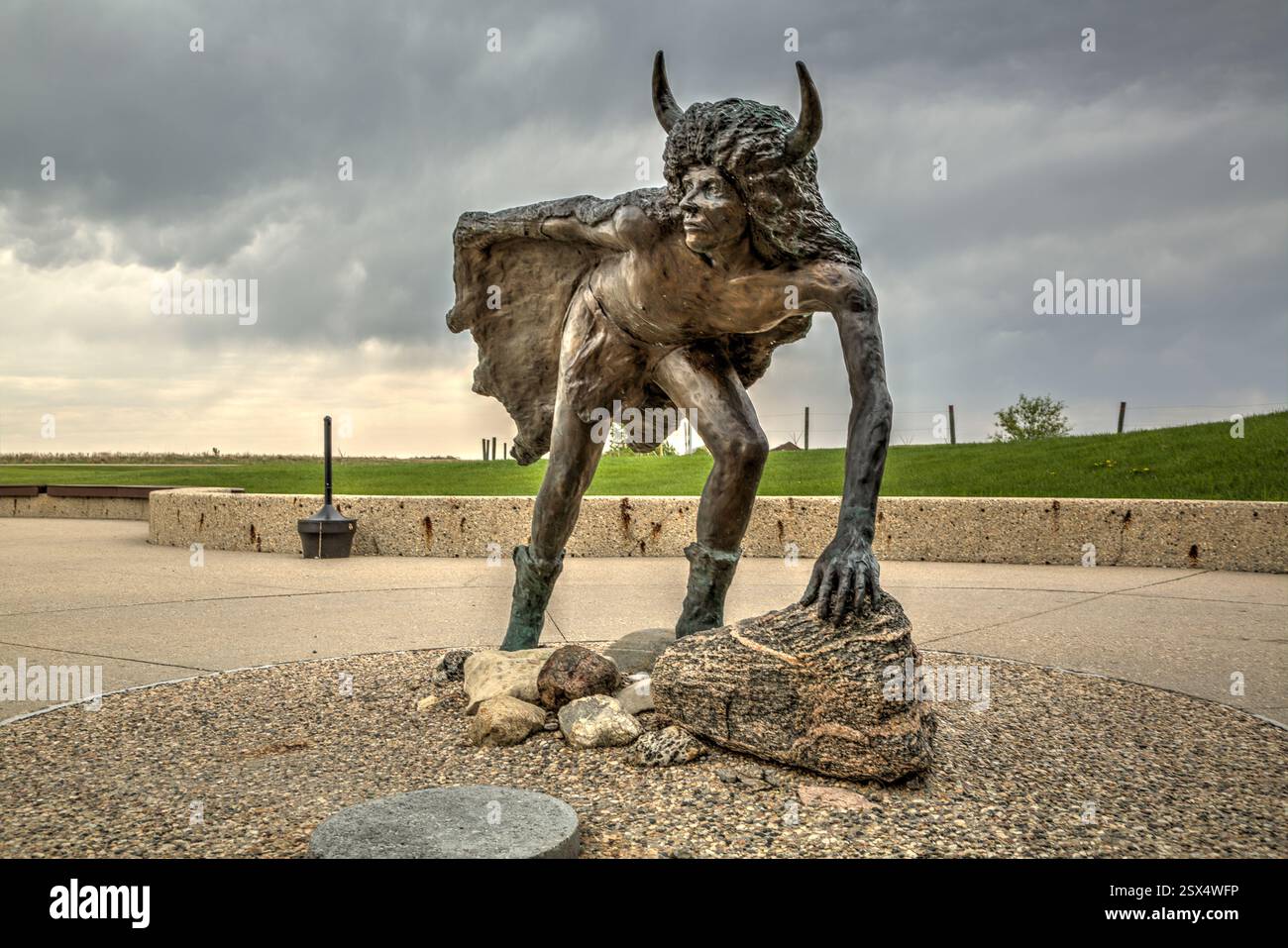 Statue of a man with horns on his head. The statue is made of bronze ...