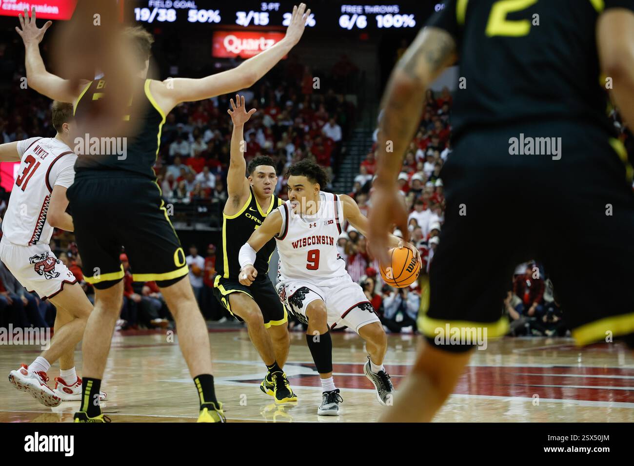 Madison, WI, USA. 22nd Feb, 2025. Wisconsin Badgers guard John Tonje (9 ...