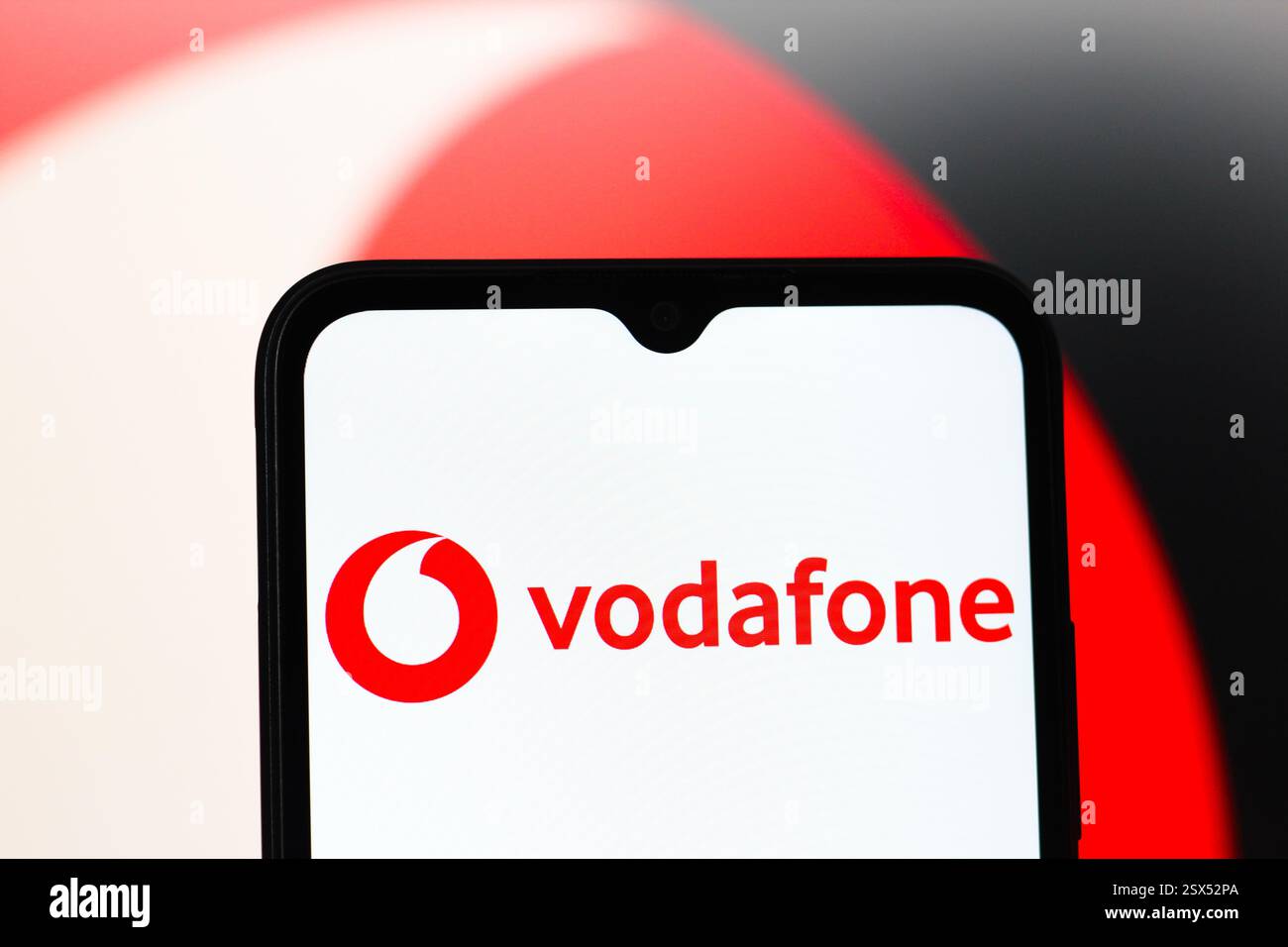In this photo illustration, the Vodafone Group logo is seen displayed on a smartphone screen ...