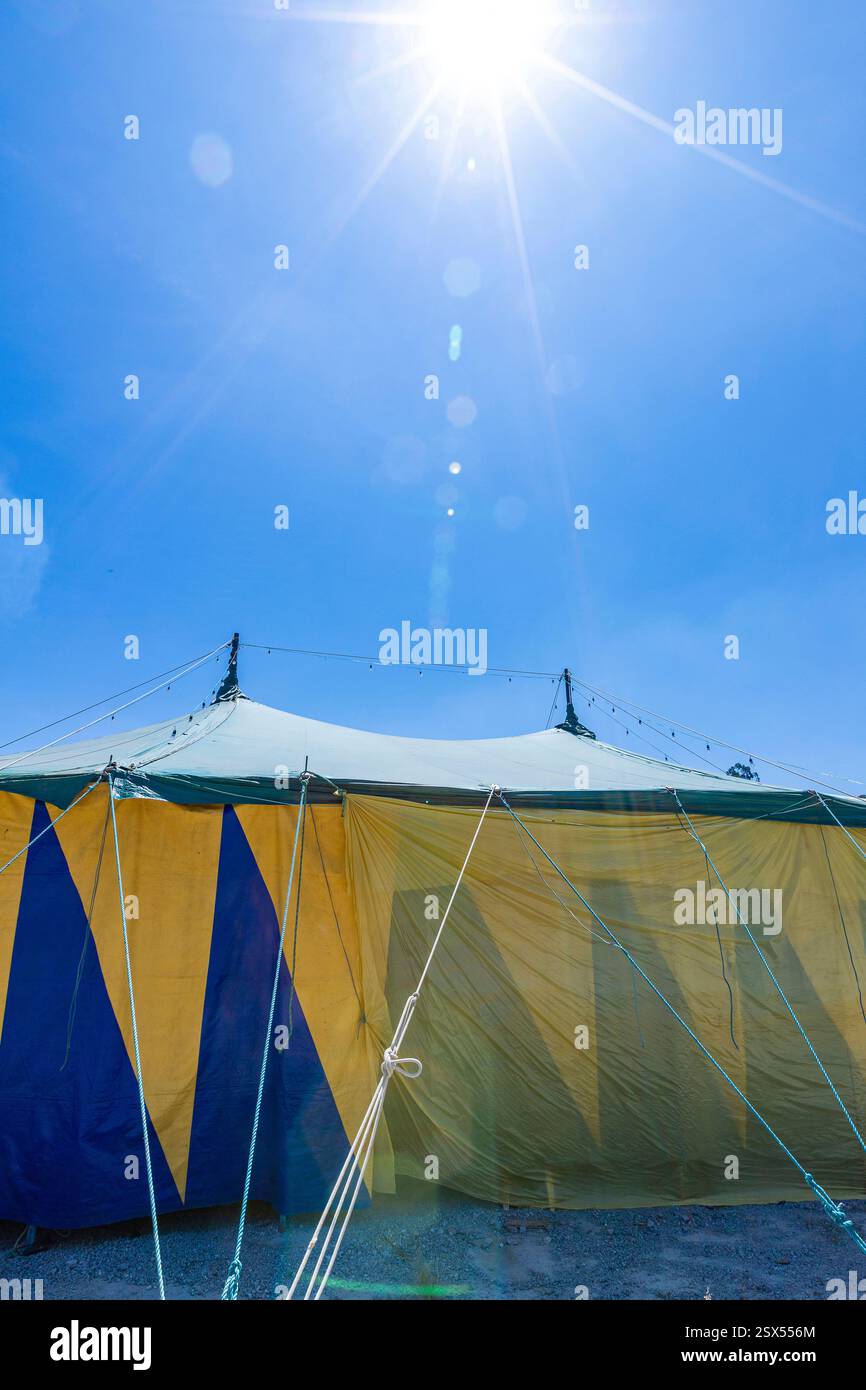 Traveling circus tent in blue, green and yellow colors. Countryside of ...
