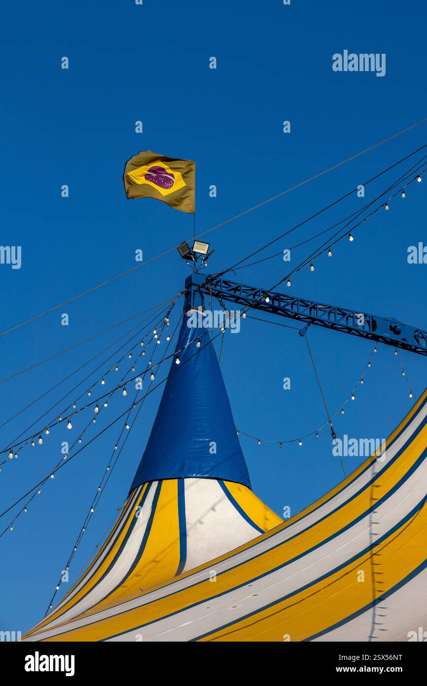 Circus tent blue, yellow and white striped pattern with brazilian flag ...