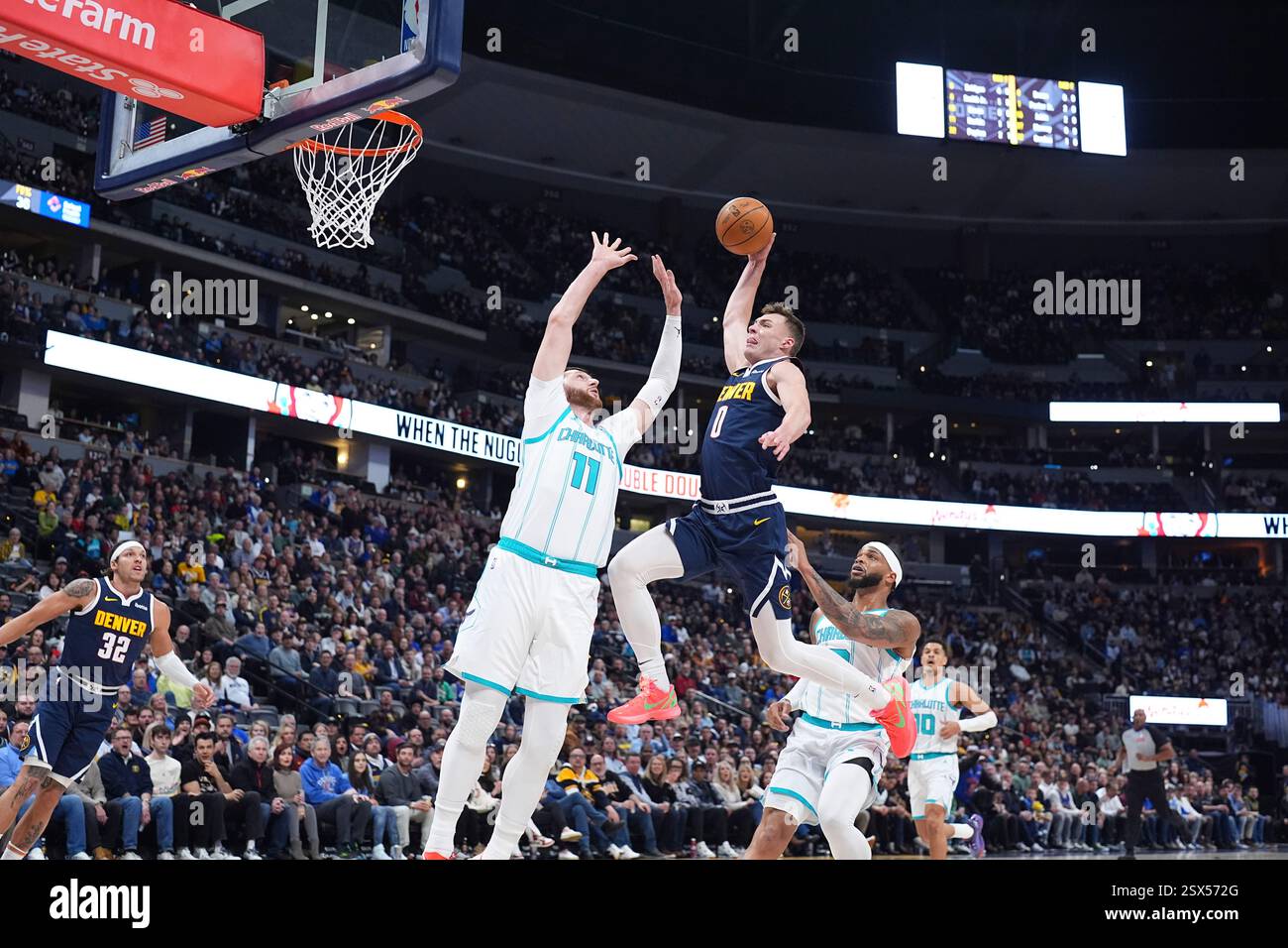 Denver Nuggets guard Christian Braun (0) drives to the basket as Charlotte Hornets center Jusuf ...