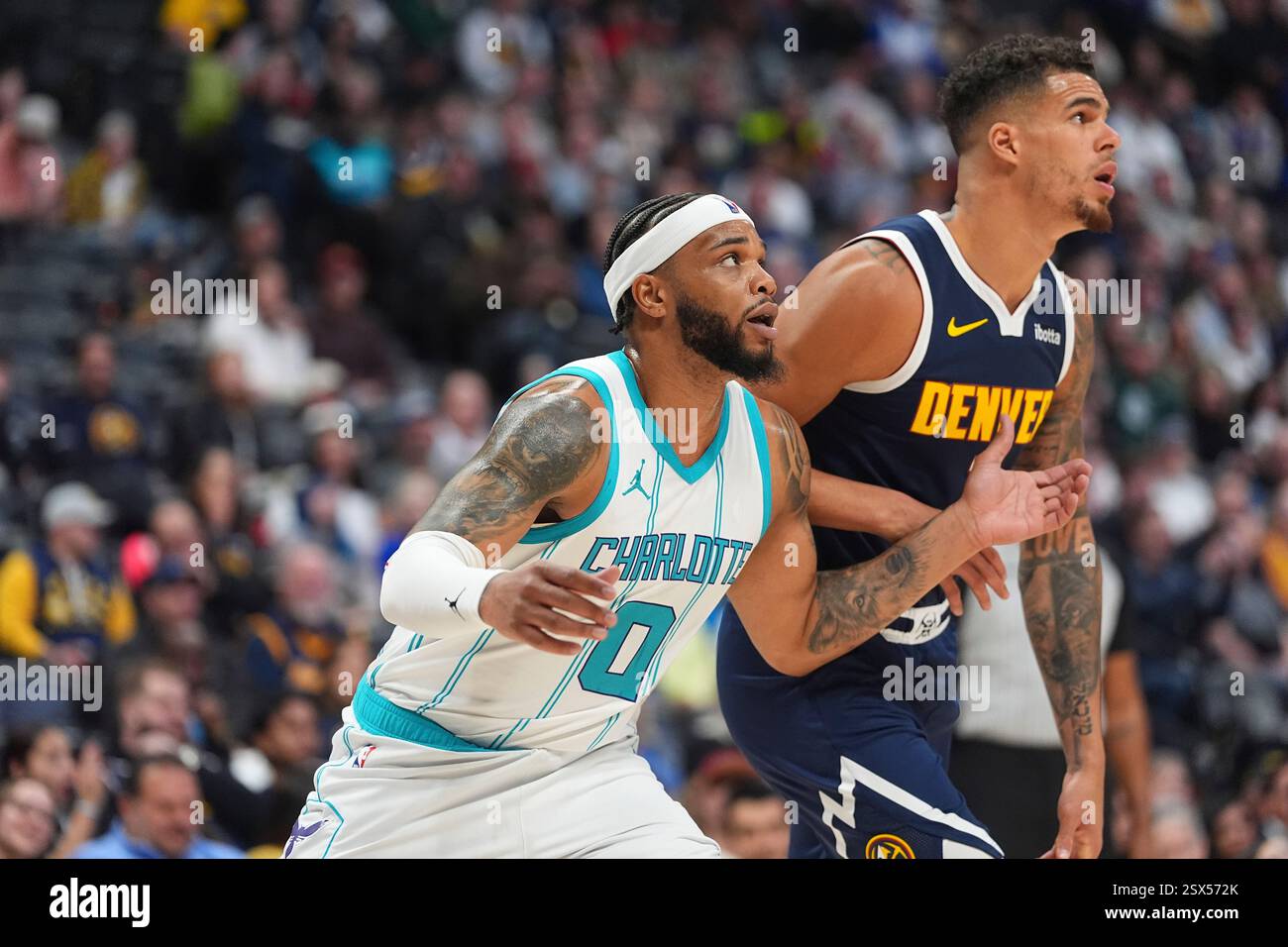 Charlotte Hornets forward Miles Bridges (0) and Denver Nuggets forward Michael Porter Jr. (1) in ...