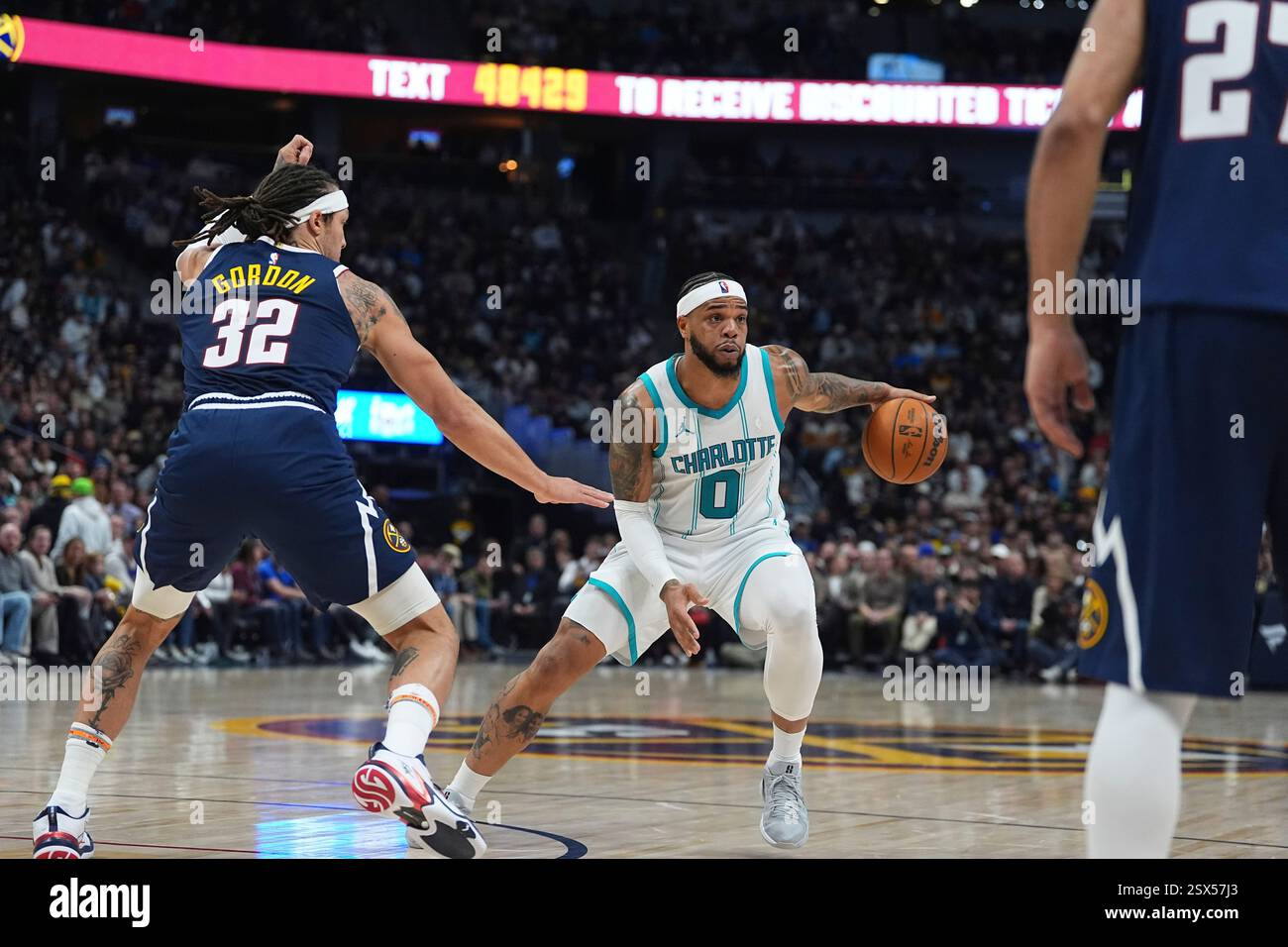 Charlotte Hornets forward Miles Bridges (0) and Denver Nuggets forward Aaron Gordon (32) in the ...