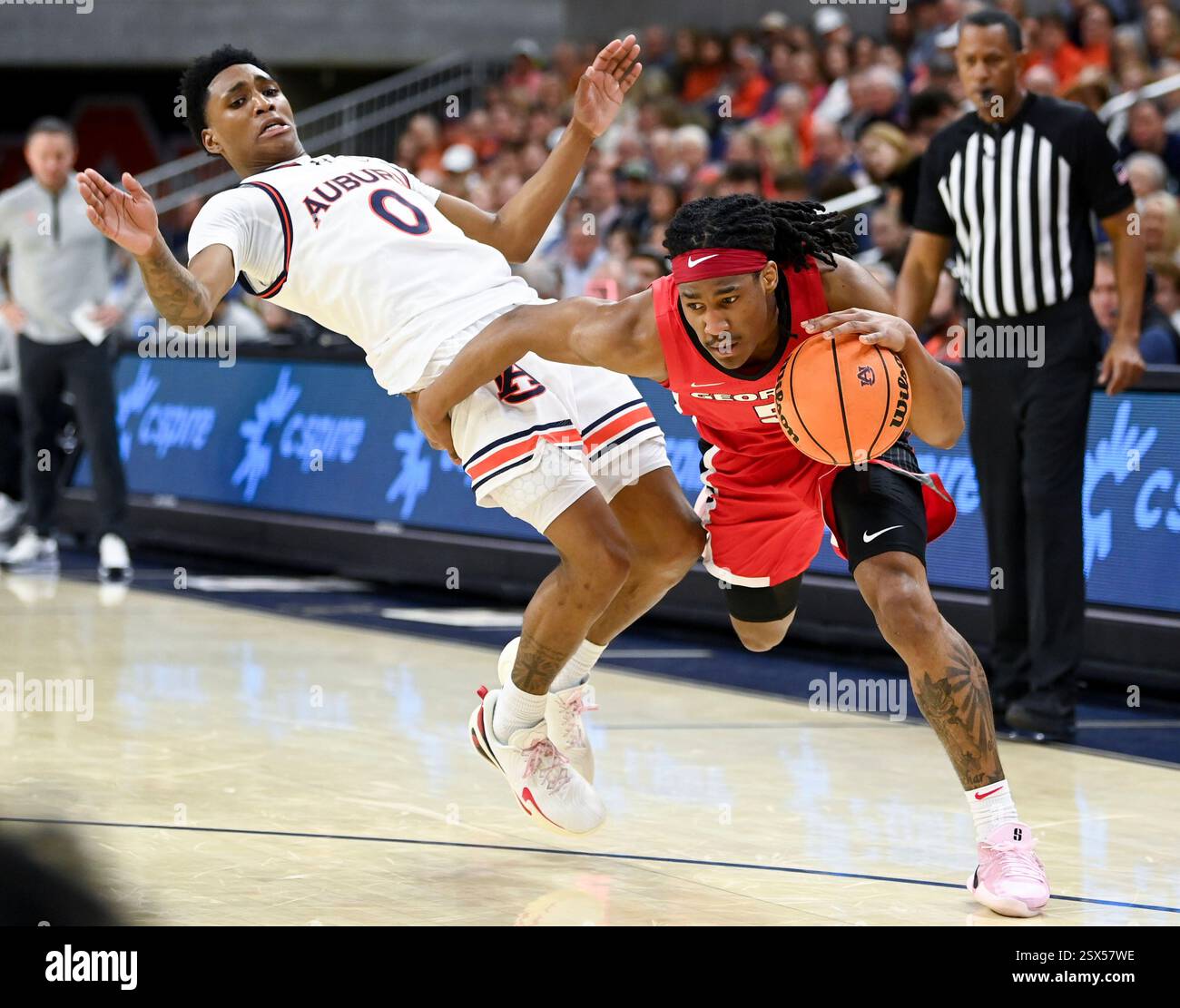 Georgia guard Silas Demary (5) drives past Auburn guard Tahaad ...