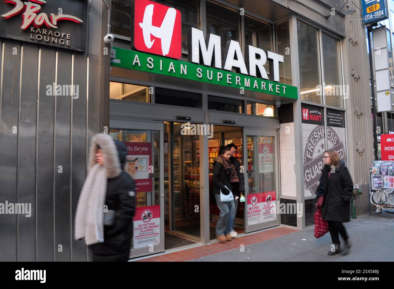 People exit an H Mart grocery store in Koreatown, Manhattan, New York ...