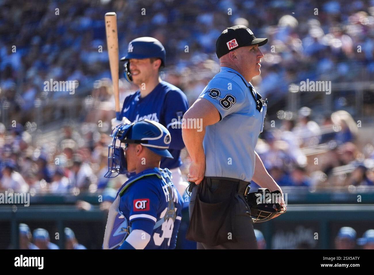 Umpire Ryan Blakney, right, announces the result of a challenged play ...