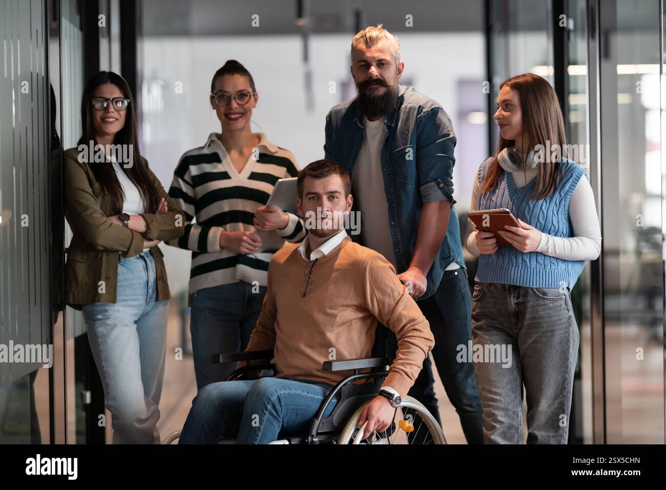 A businessman with disability in a wheelchair is surrounded by ...