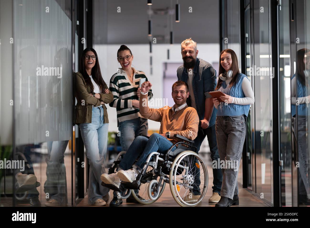 A businessman with disability in a wheelchair is surrounded by ...