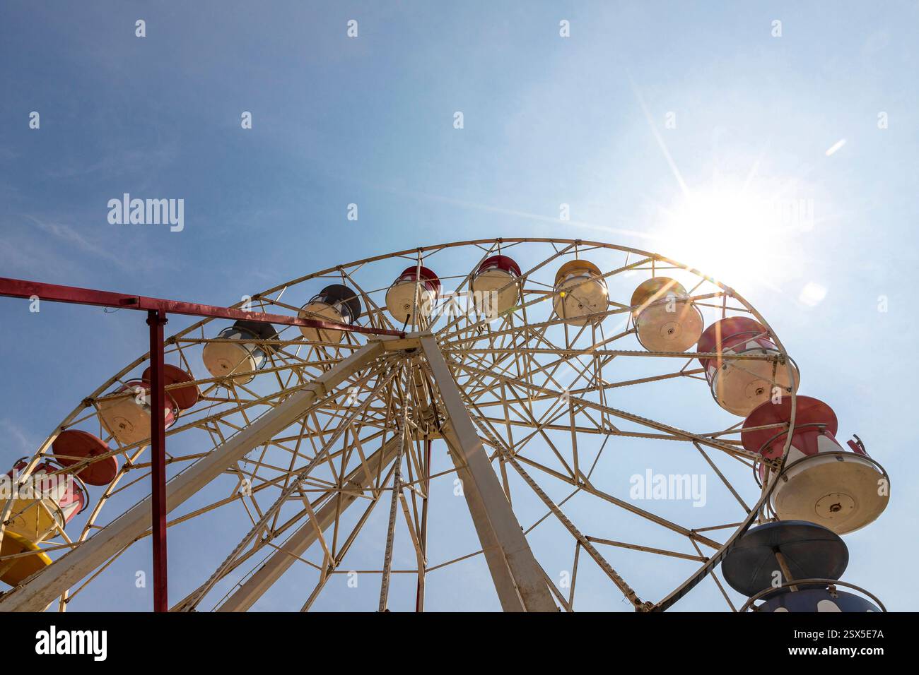 Colorful giant wheels in park amusement with blue sky on background ...