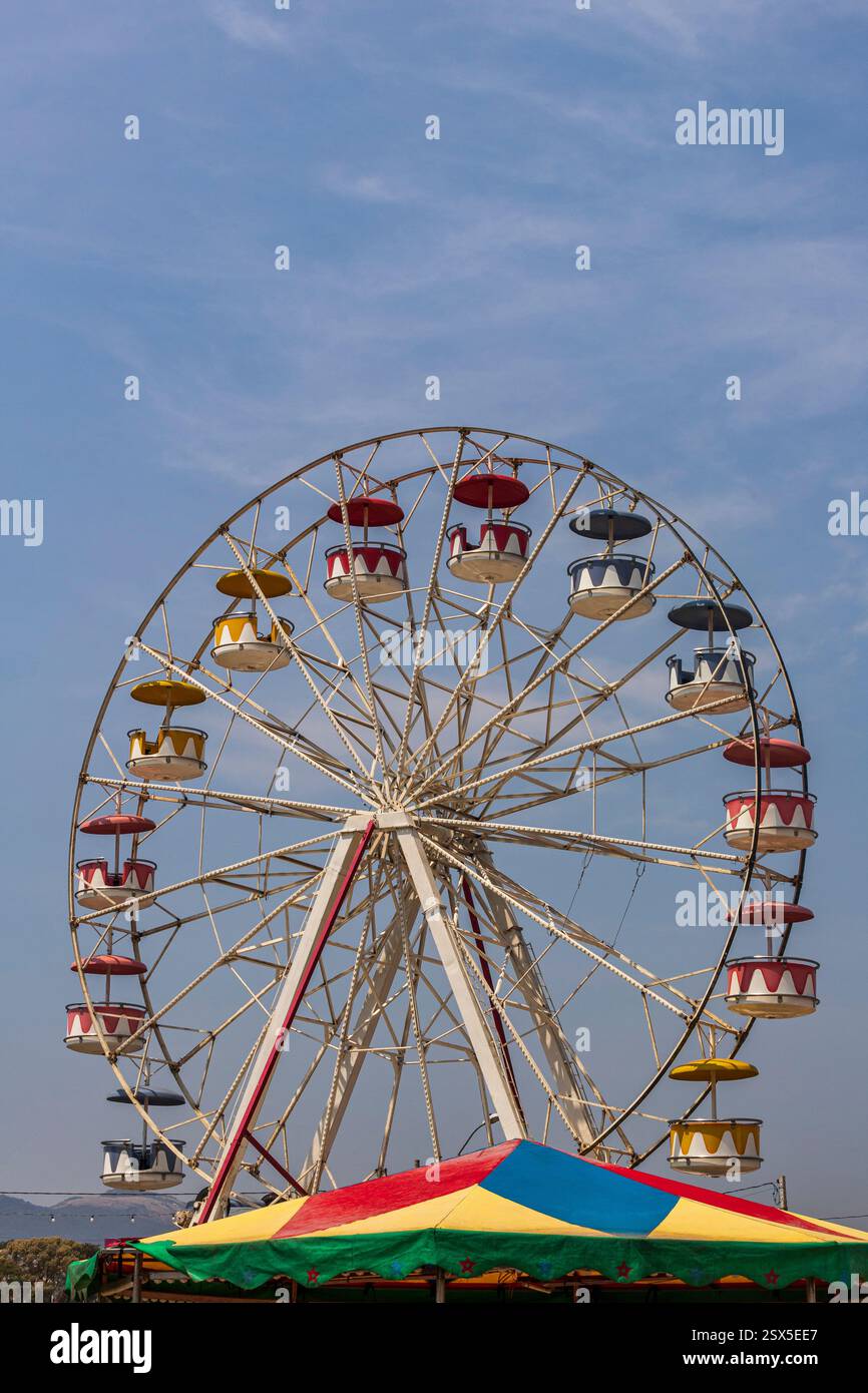 Colorful giant wheels in park amusement with blue sky on background ...