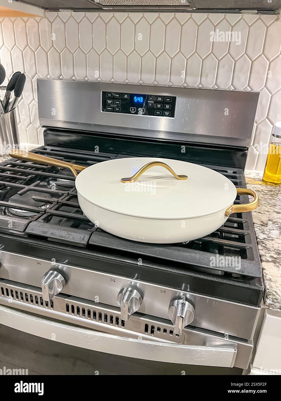 Modern White Pan on Gas Stove Top Stock Photo - Alamy