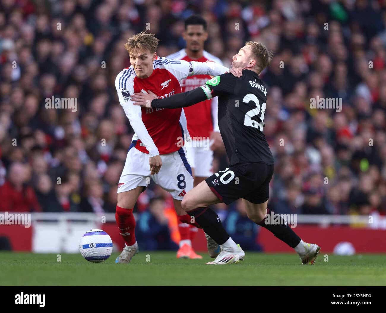 London, UK. 22nd Feb, 2025. Martin Odegaard (A) Jarrod Bowen (WHU) at ...
