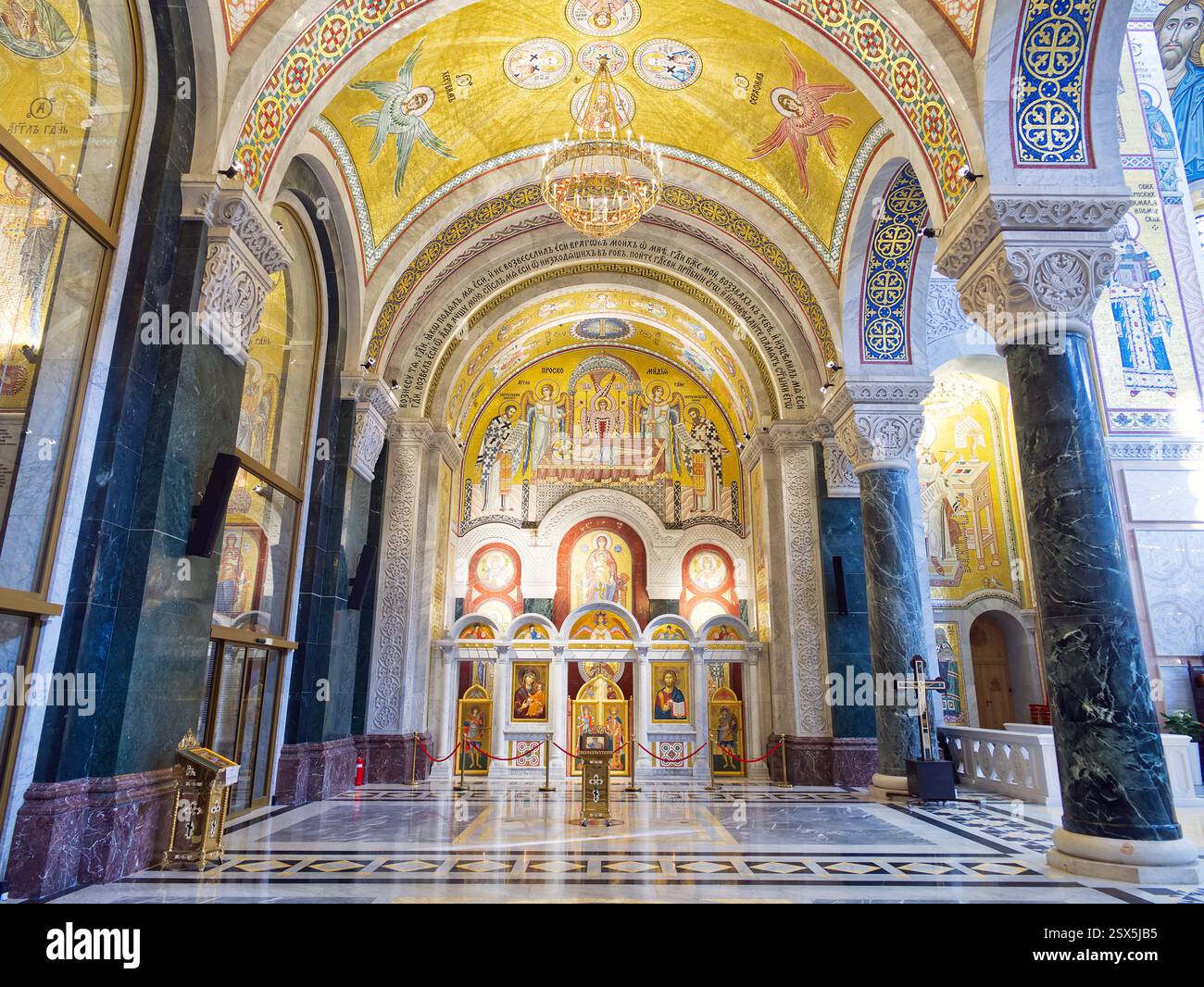 Richly decorated church interior with golden mosaics, arches, and ...