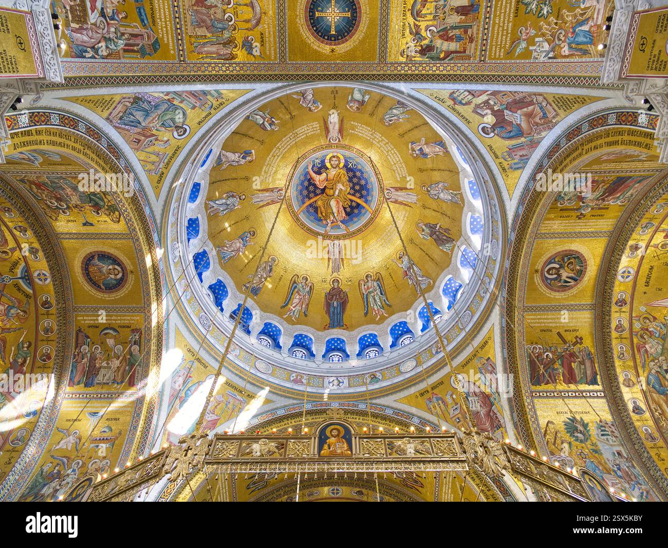 Elaborate golden mosaic dome with religious imagery in a Byzantine-style cathedral interior ...