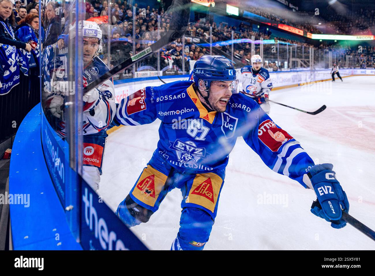 Sven Leuenberger #61 (EV Zug) and Alessandro Segafredo #17 (ZSC Lions ...