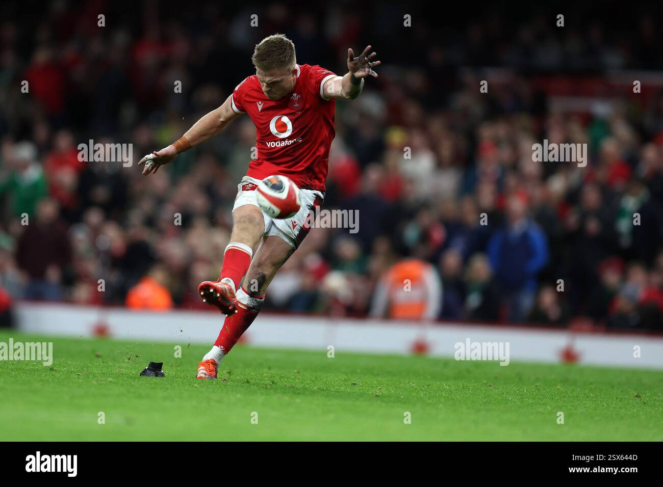 Cardiff, UK. 22nd Feb, 2025. Gareth Anscombe of Wales kicks a ...