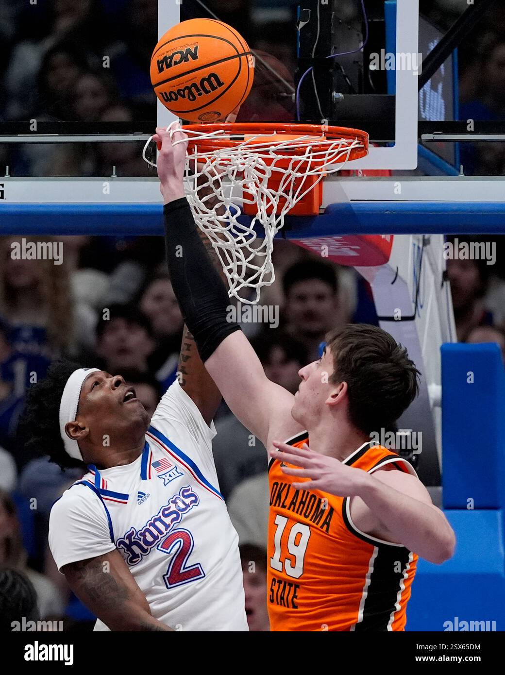 Kansas guard AJ Storr (2) gets past Oklahoma State forward Andrija ...