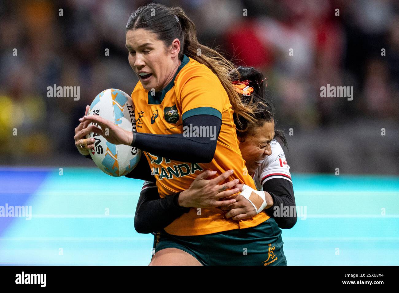 Canada's Asia Hogan-Rochester, back, tackles Australia's Charlotte ...