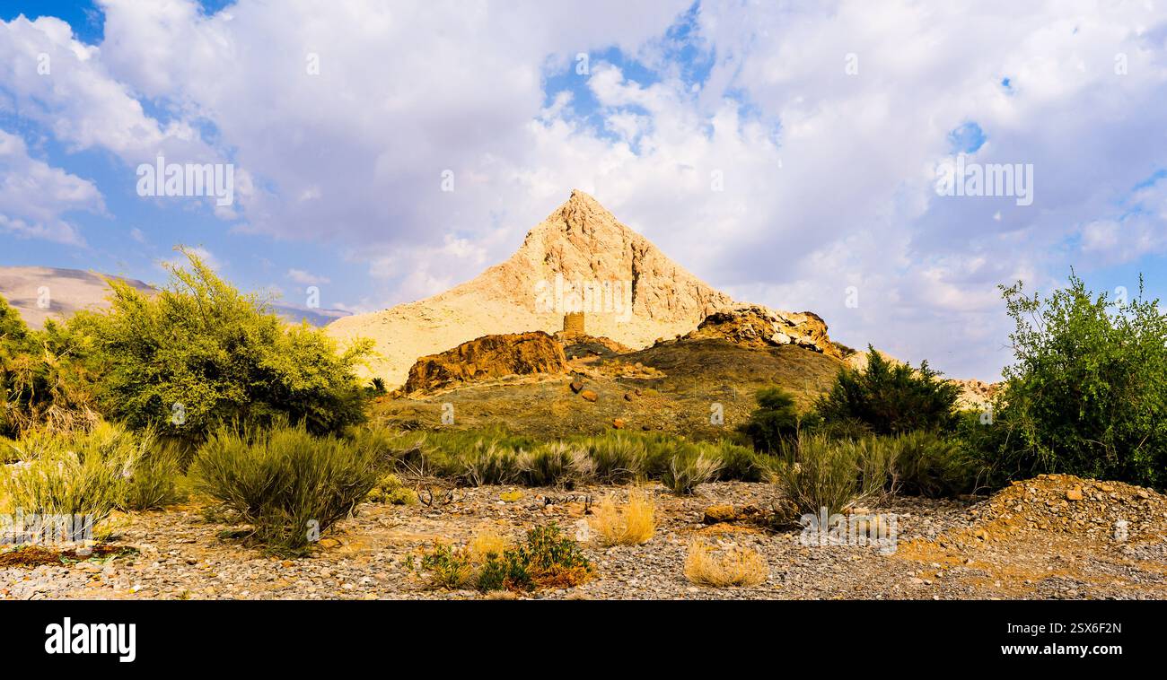 Pyramid mount and ruins in Oman against cloudy sky Stock Photo - Alamy