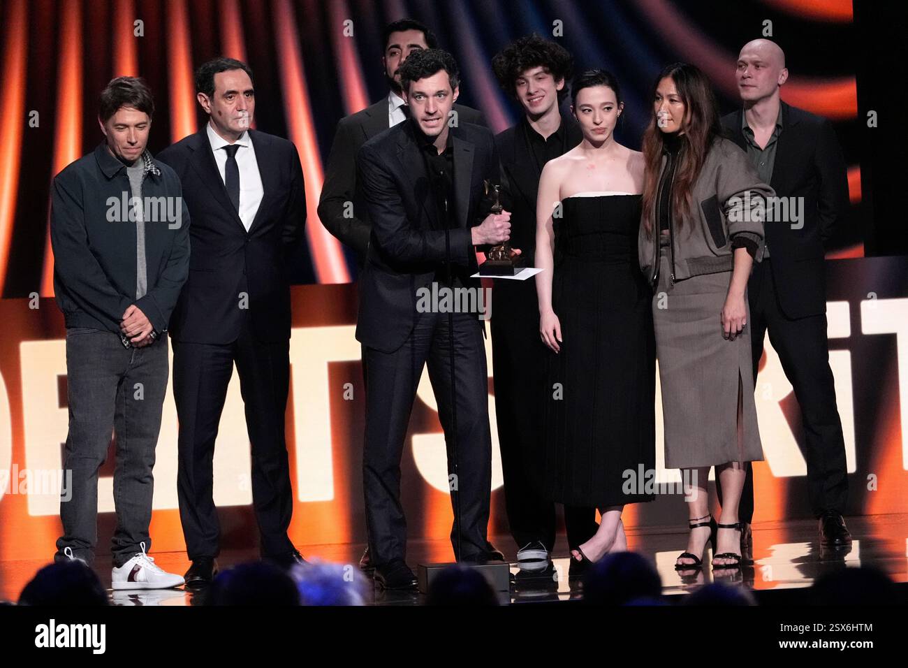 Alex Coco, center, accepts the award for best feature for "Anora ...