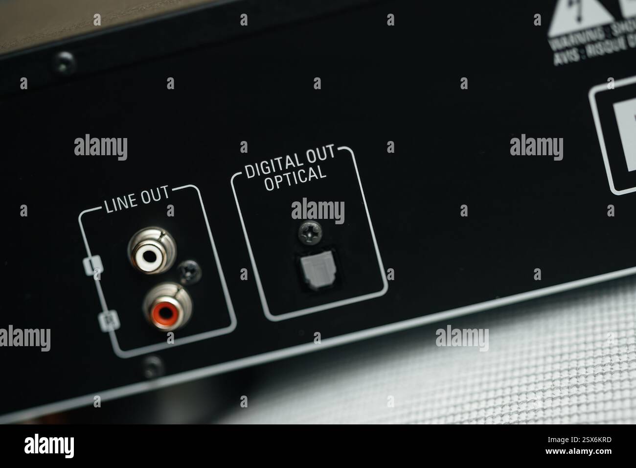 A close-up view of the back panel of an audio device, featuring RCA ...