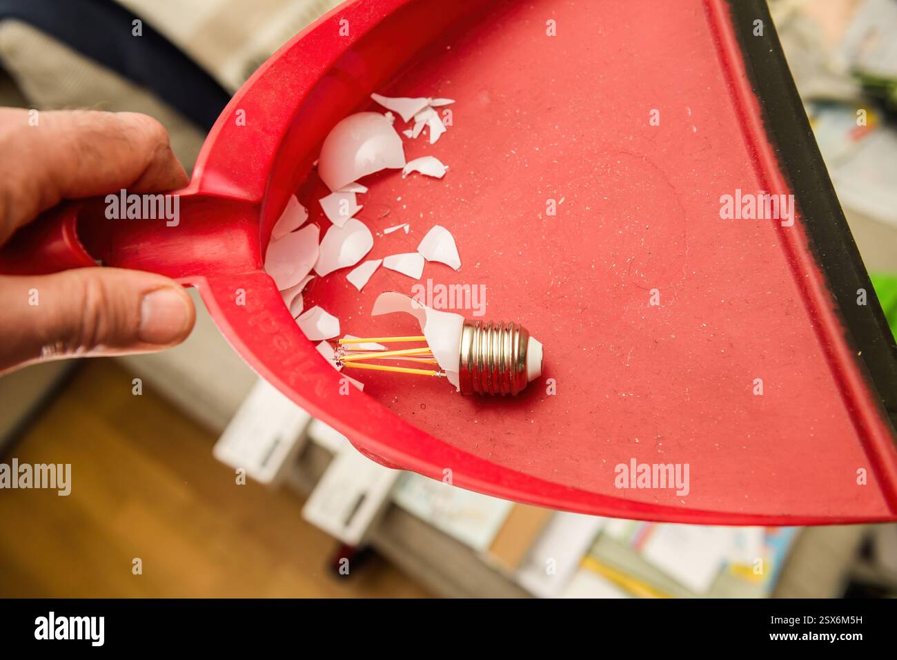 A broken LED light bulb with shattered glass pieces and exposed ...