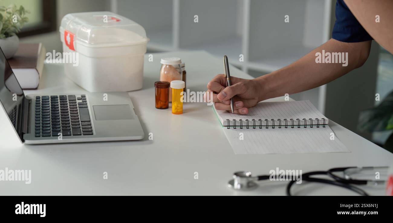 Medical student documenting medication information while studying at a ...