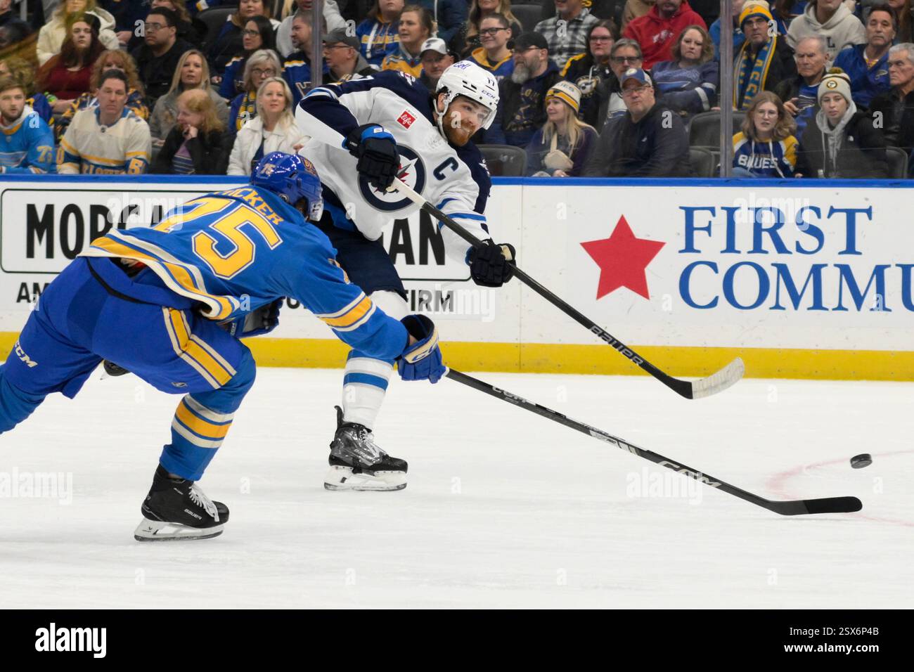 St. Louis Blues defenseman Tyler Tucker, left, blocks a shot from ...