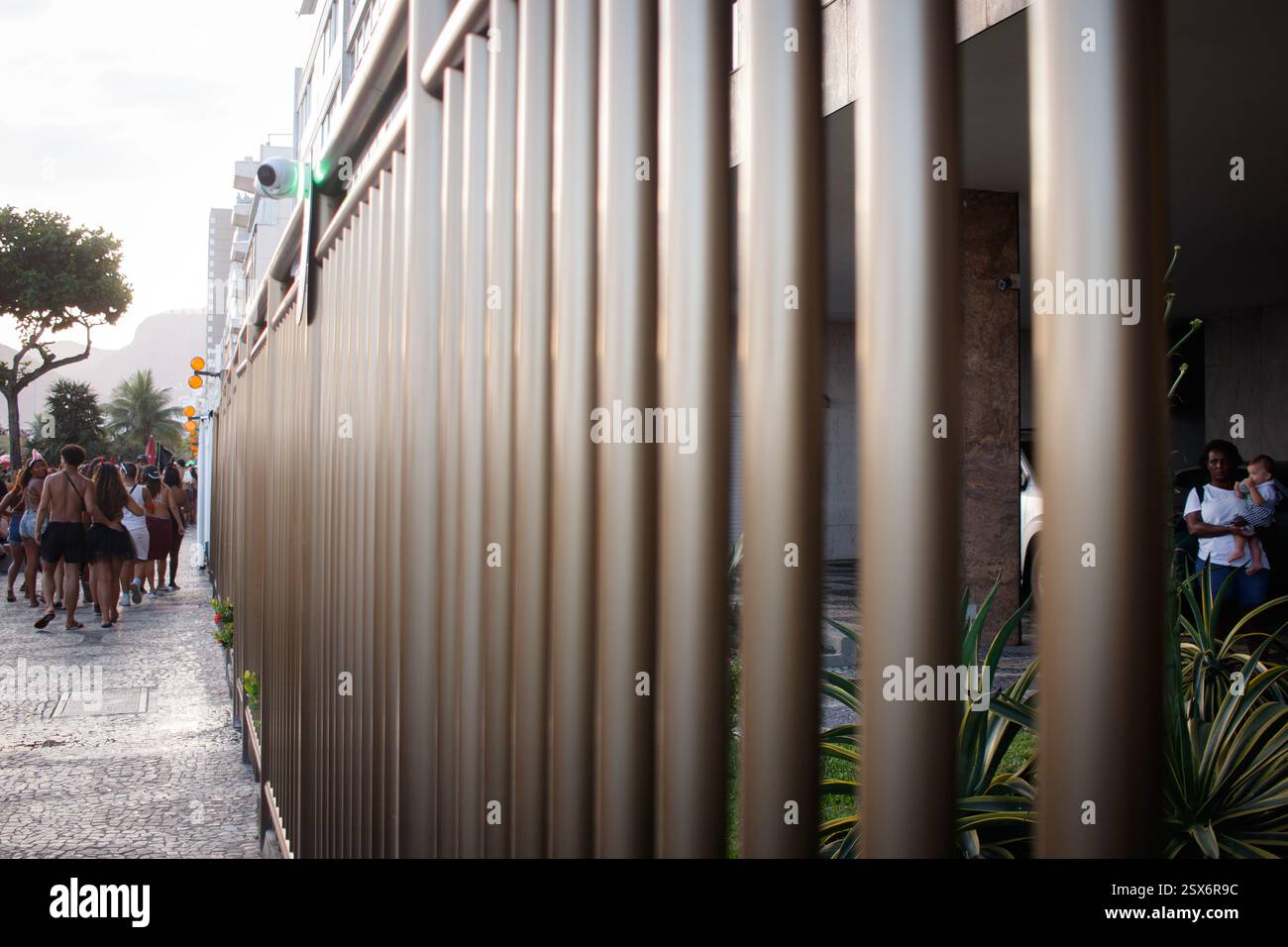 22 February 2025, Brazil, Rio De Janeiro: A childcare worker watches ...