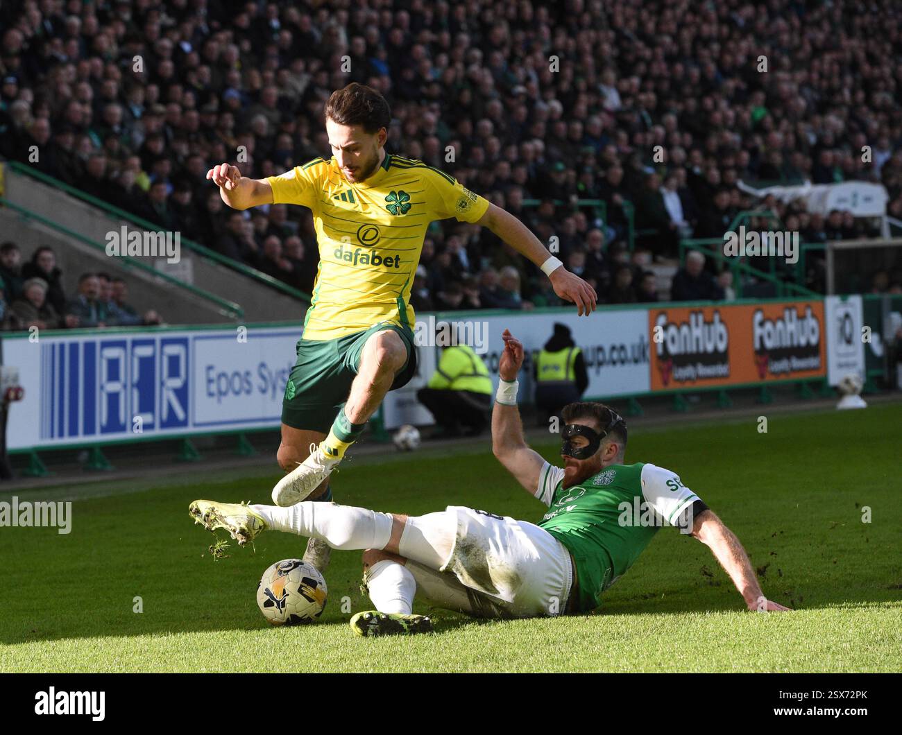 Celtic nicolas kyhn evades hibs nicky cadden tackle hi-res stock ...