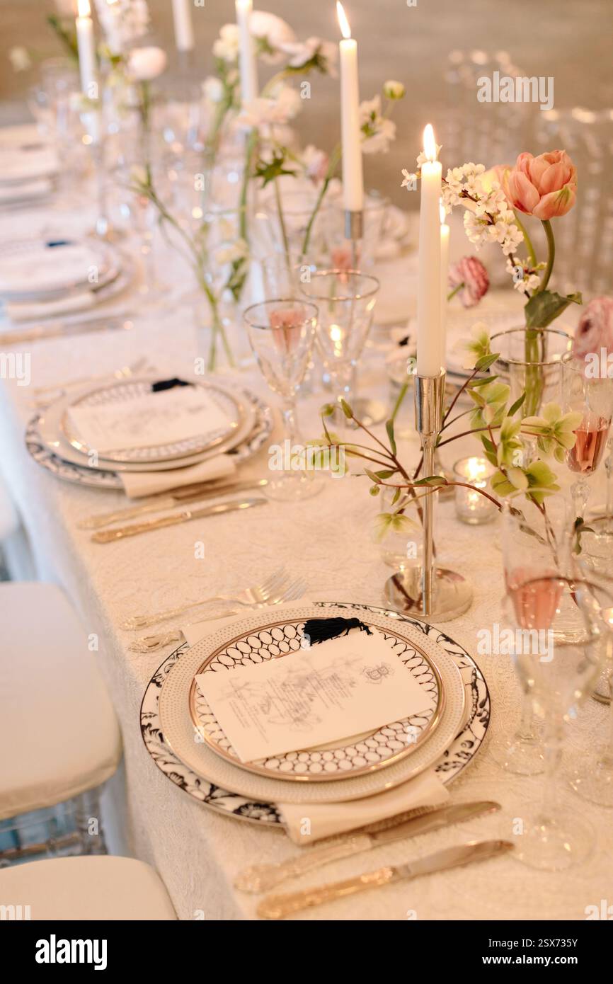 A beautifully arranged dining table with candles and floral decorations ...