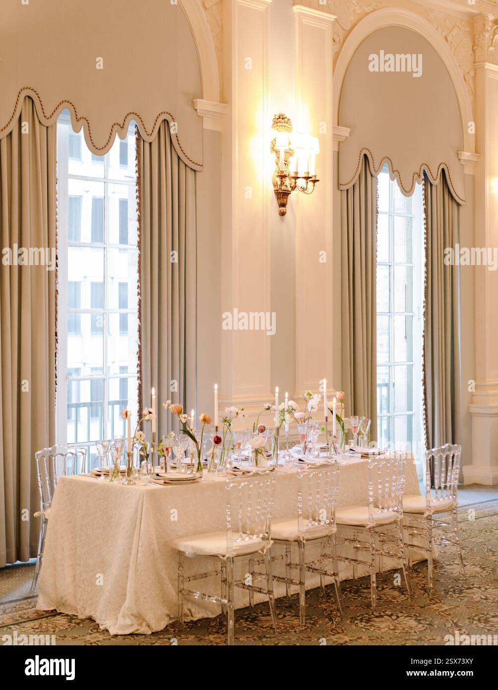 A beautifully arranged dining table in a sophisticated hall, featuring ...