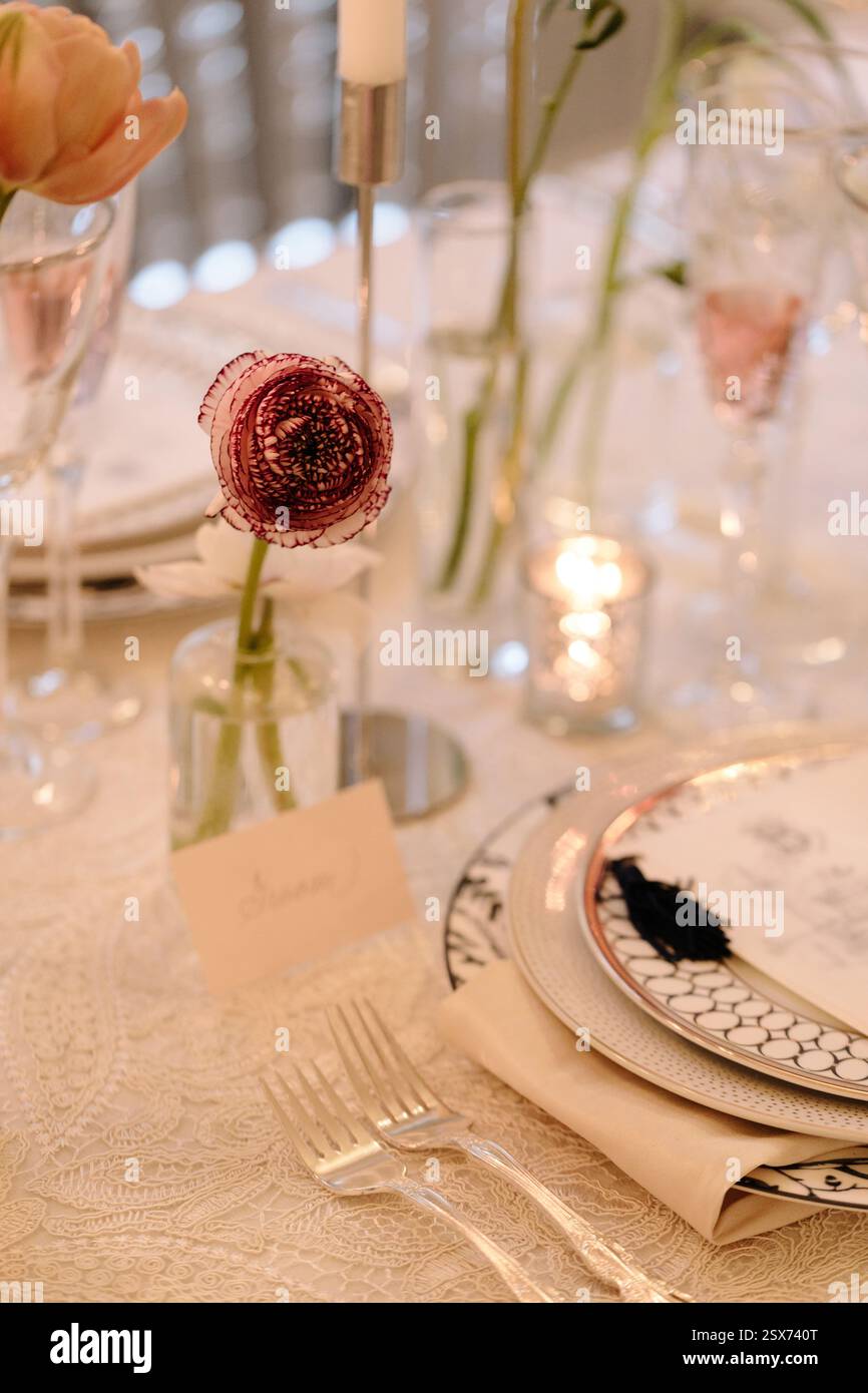 Sophisticated dining arrangement featuring floral accents, glassware ...
