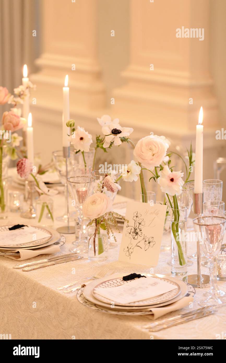 A beautifully set dining table with flowers, candles, and fine ...
